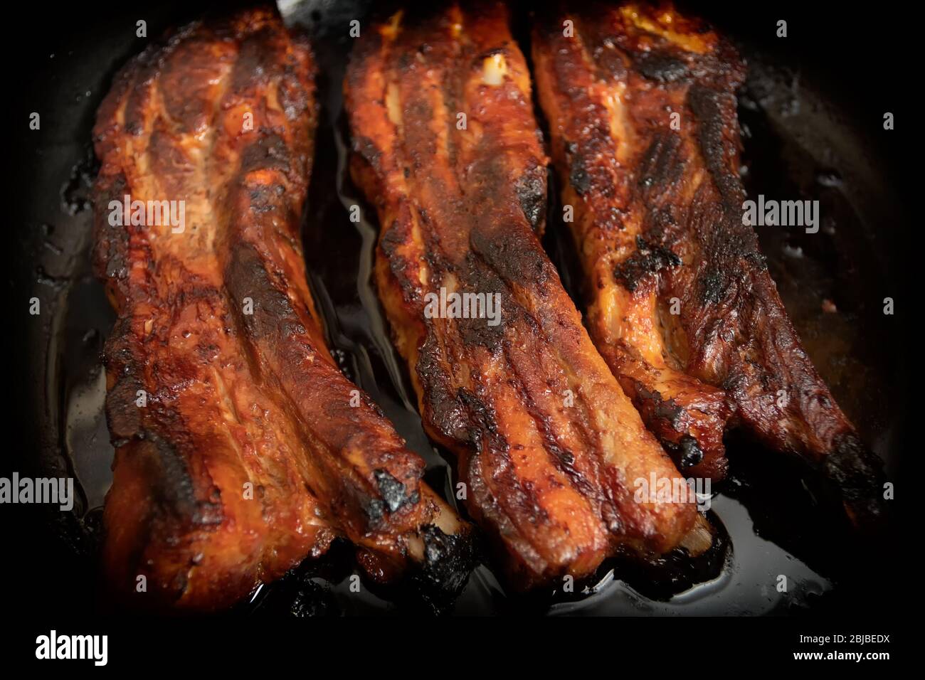 Juicy fried pork ribs in a pan Stock Photo - Alamy