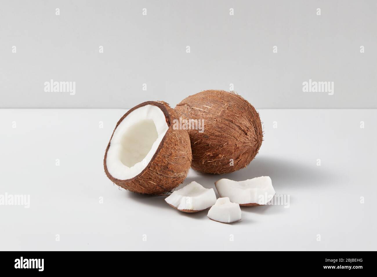 Composition from parts of fresh ripe natural coconuts fruits on a grey background Stock Photo ...