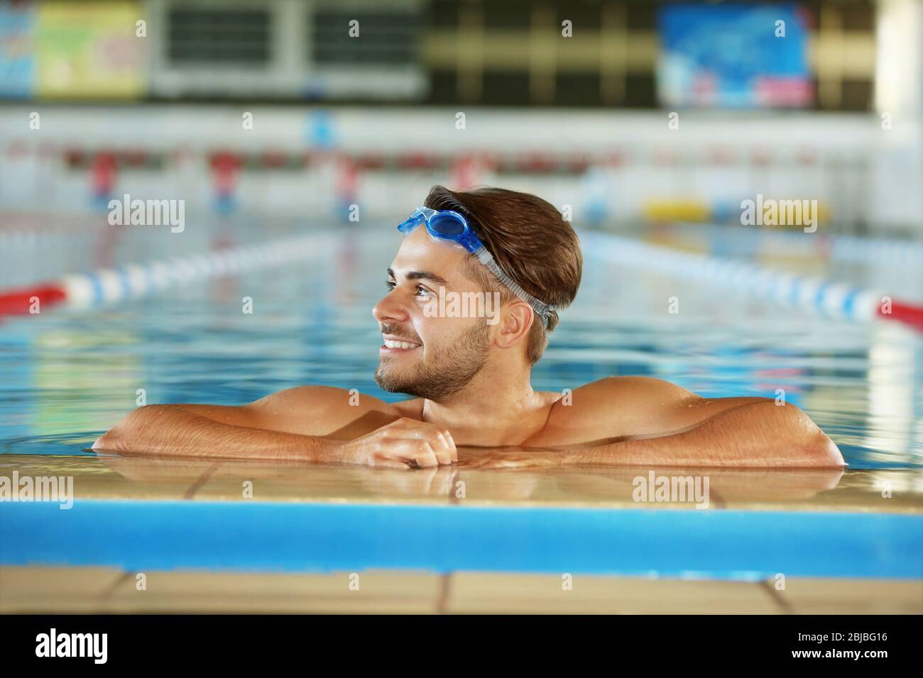Young man in swimming pool Stock Photo - Alamy