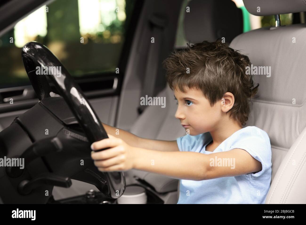 Boy driving parent car Stock Photo - Alamy