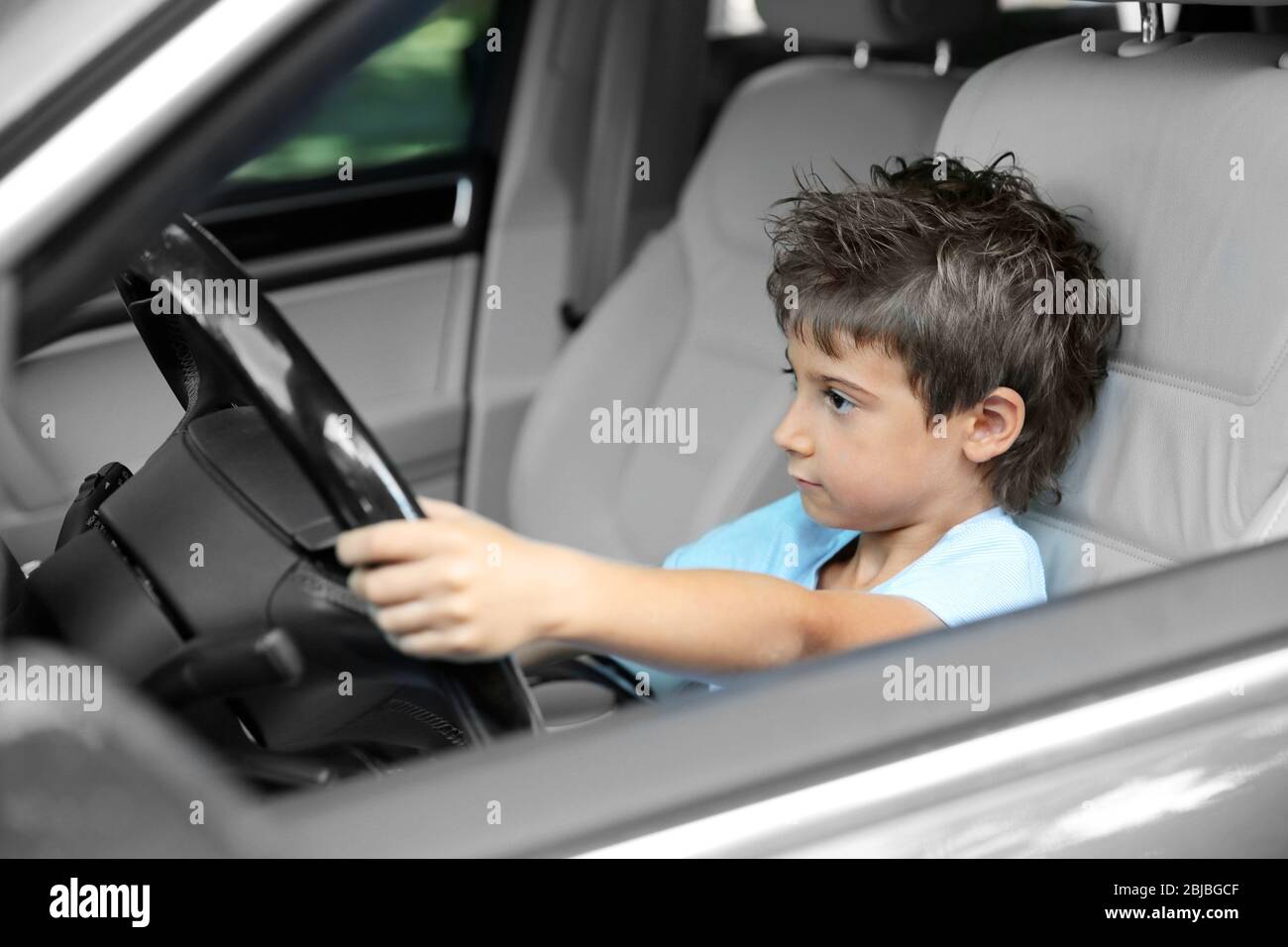 Boy driving parent car Stock Photo - Alamy
