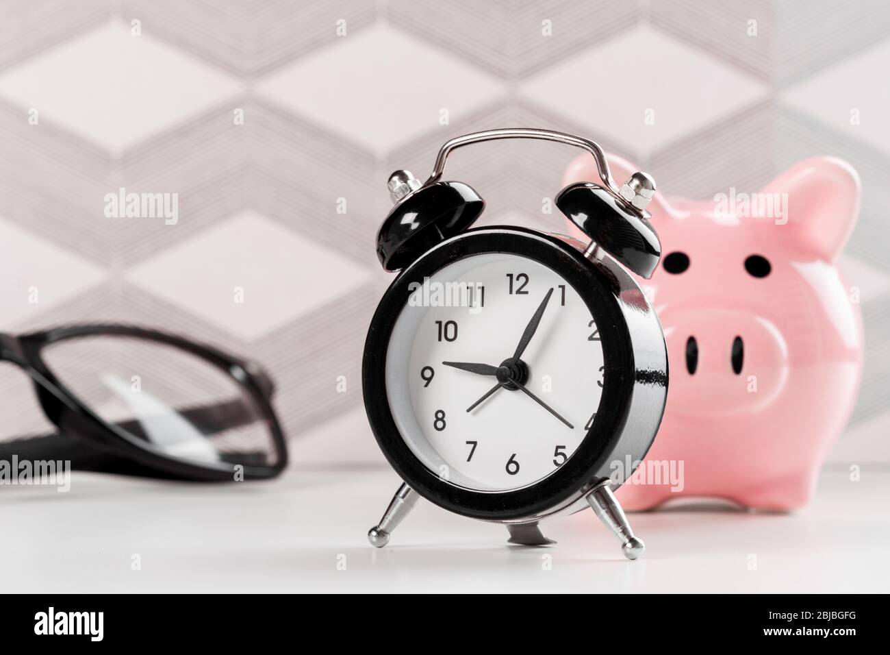 Alarm clock and piggy bank concept for saving time Stock Photo - Alamy
