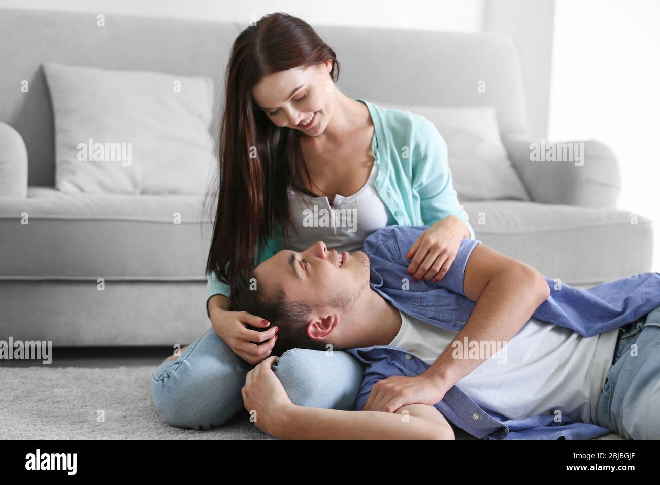 Happy couple hugging on floor Stock Photo - Alamy