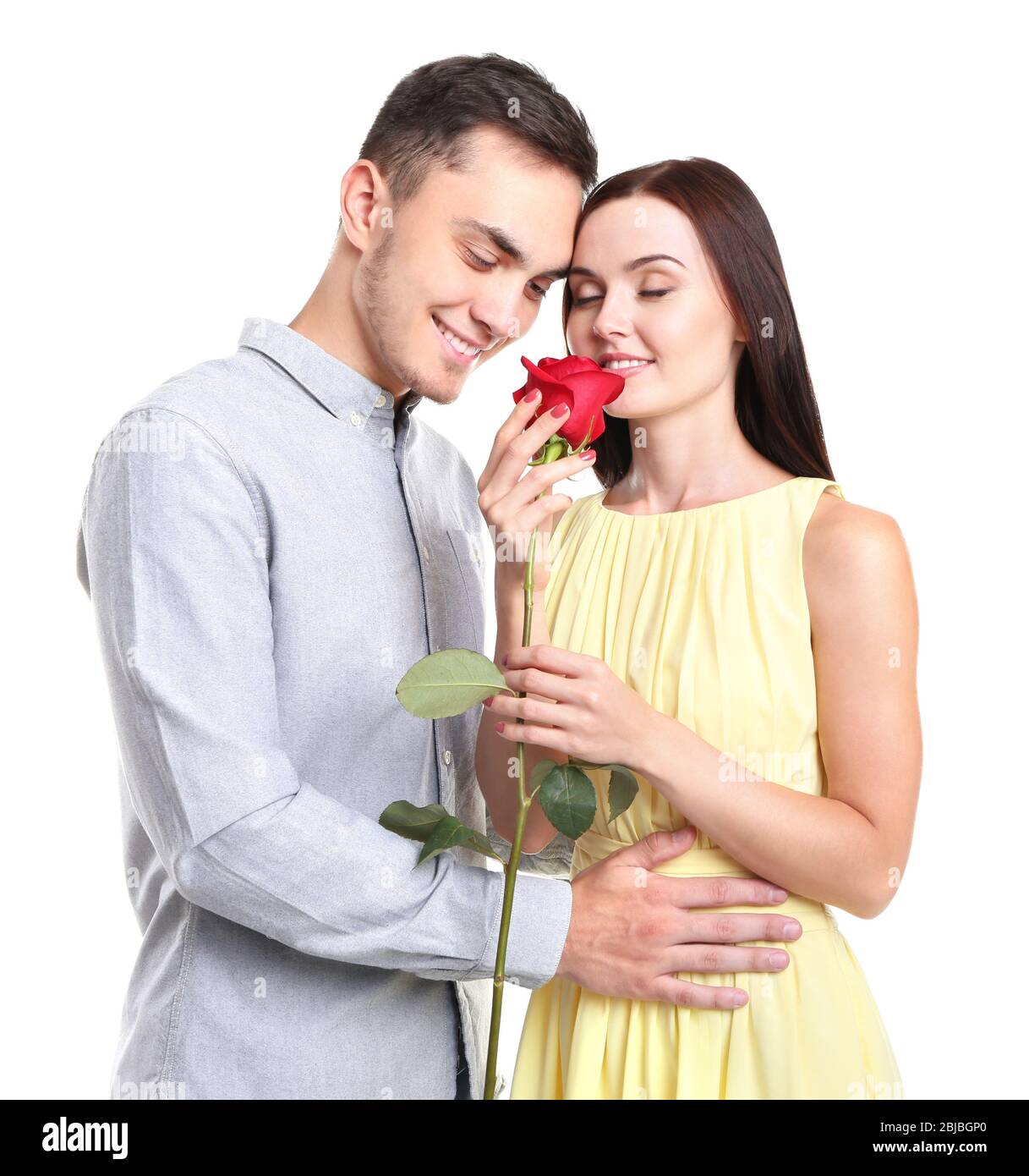 Happy couple with red rose on white background Stock Photo - Alamy