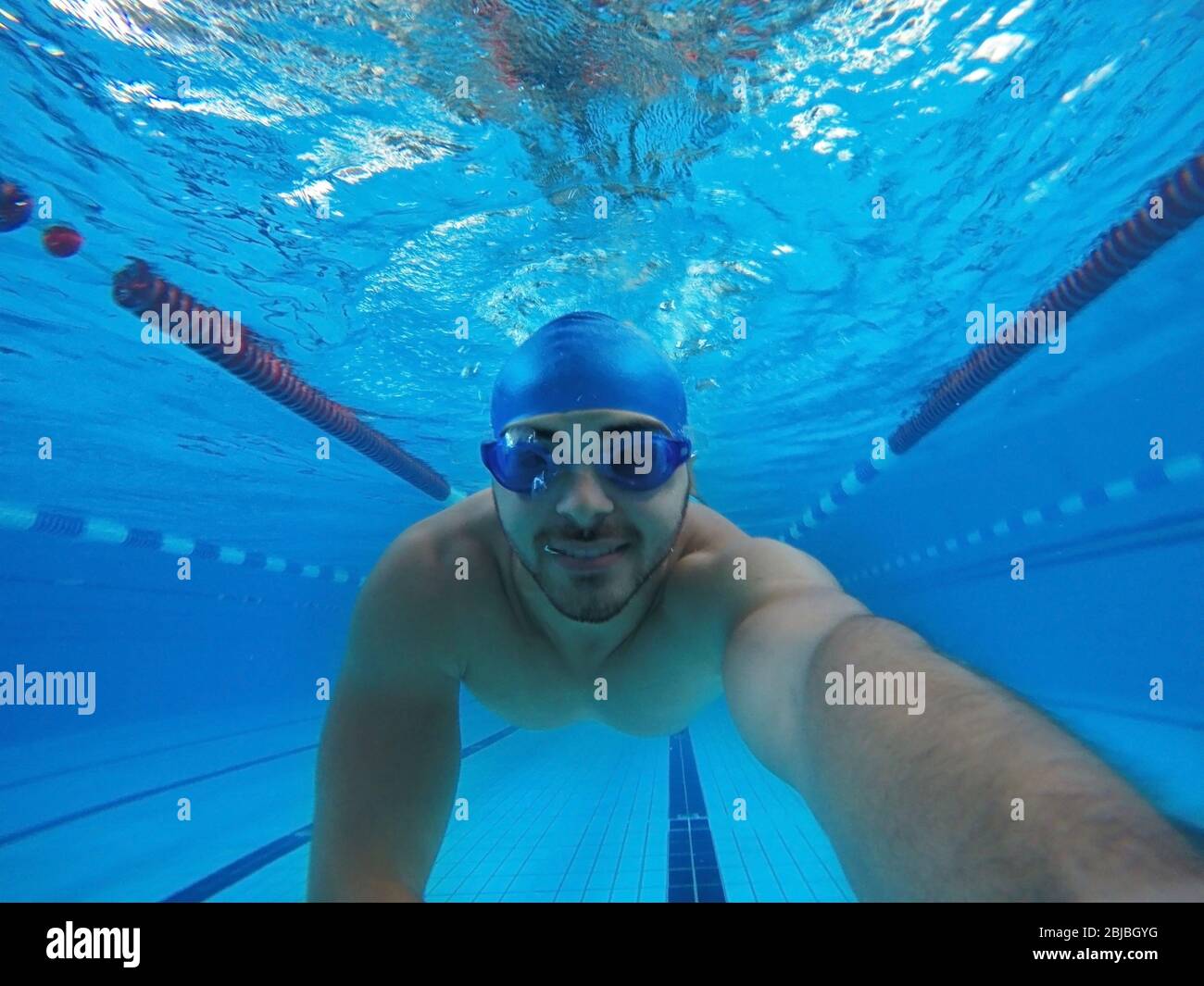 Young man swimming underwater in pool hi-res stock photography and ...