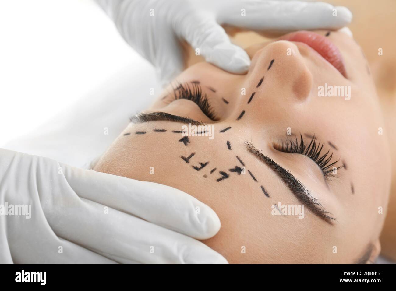 Plastic surgery concept. Specialist checking female face Stock Photo ...