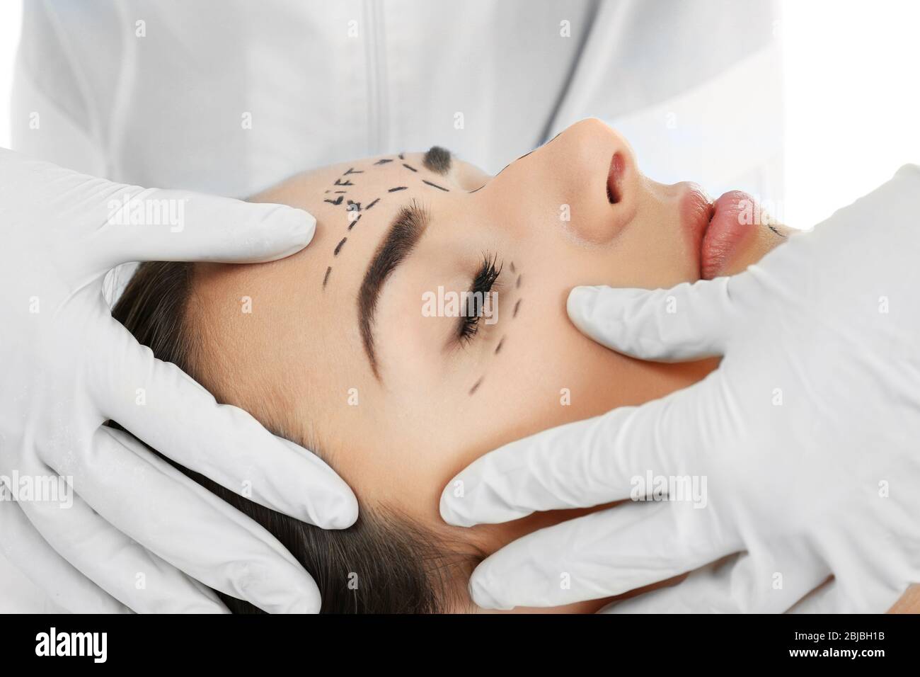 Plastic surgery concept. Specialist checking female face Stock Photo ...