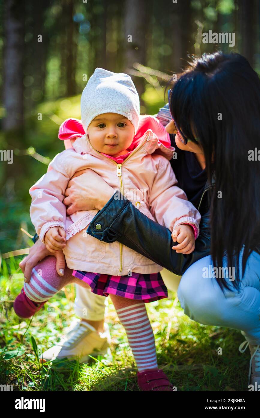 Adorable baby on forest path in nature.1 year old girl in woods with ...