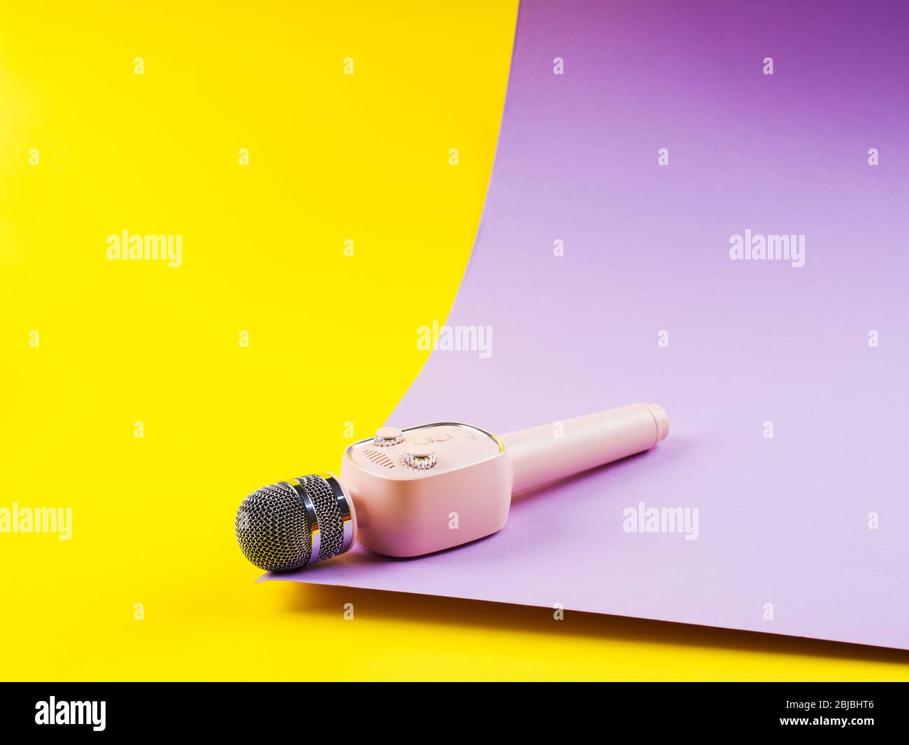 Pastel pink microphone on colorful background Stock Photo - Alamy