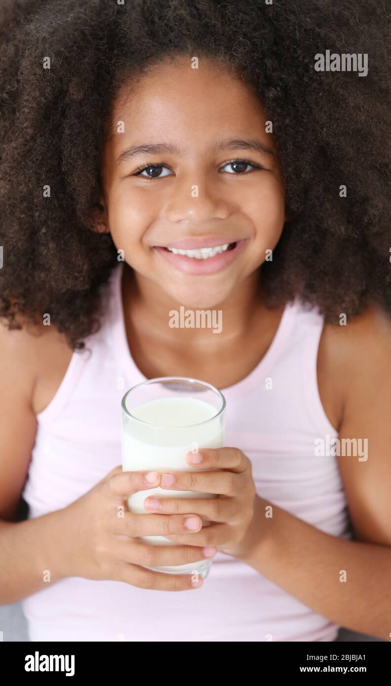 Curly African-American girl drinking milk, closeup Stock Photo - Alamy