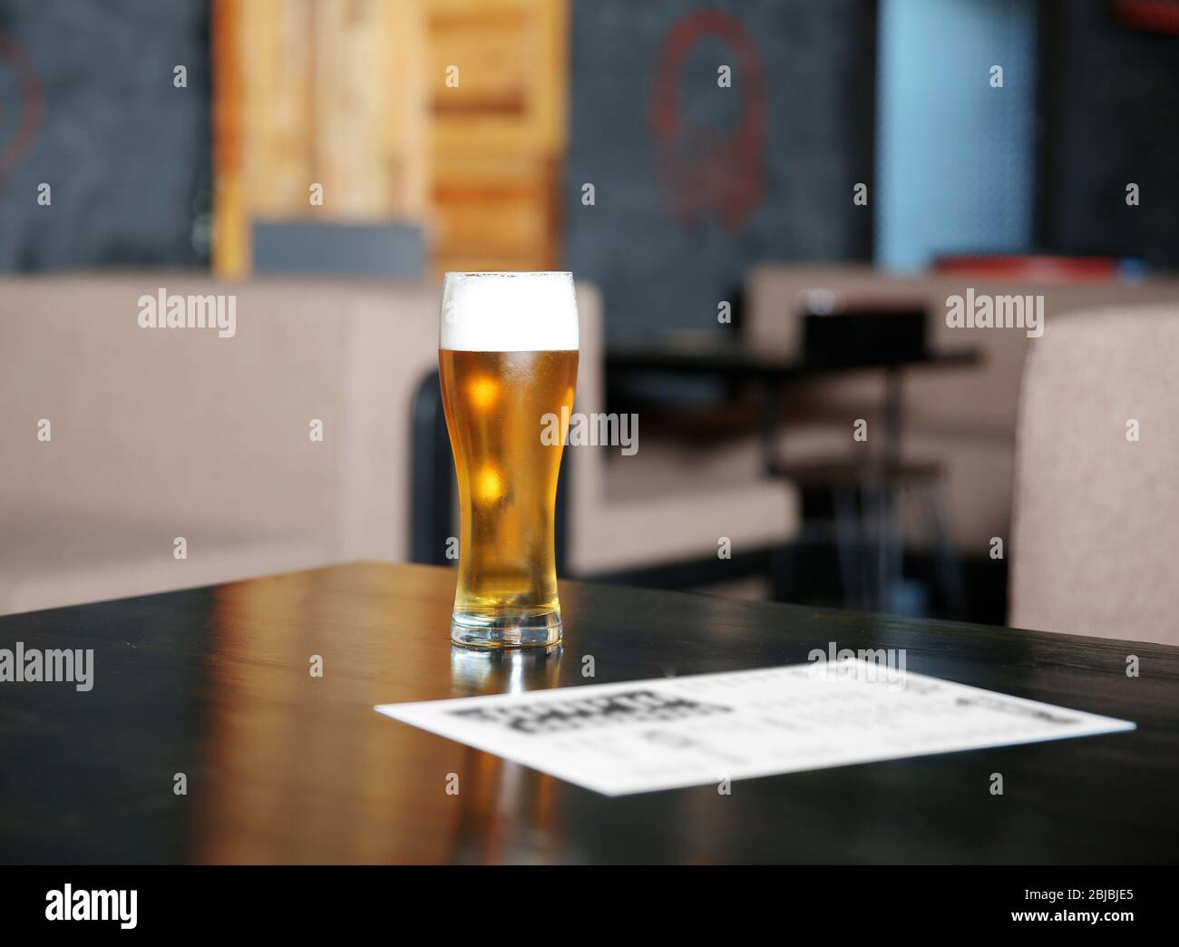 Glass of beer on bar counter in modern cafe Stock Photo - Alamy