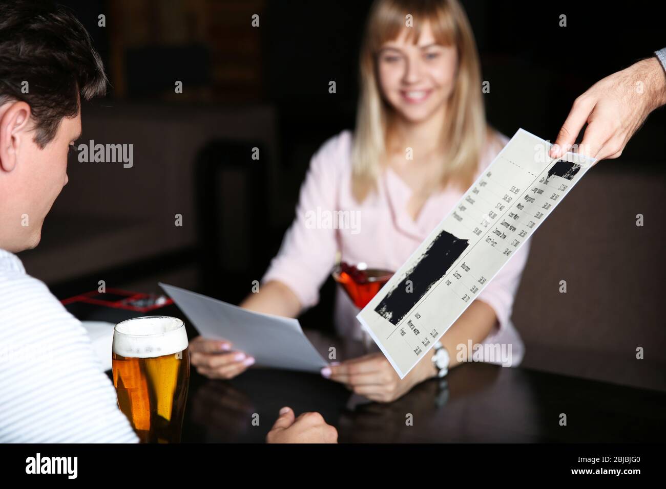 Waiter taking order from visitors in cafe Stock Photo - Alamy