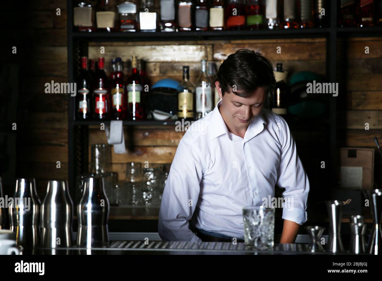 Bartender working at bar counter Stock Photo - Alamy