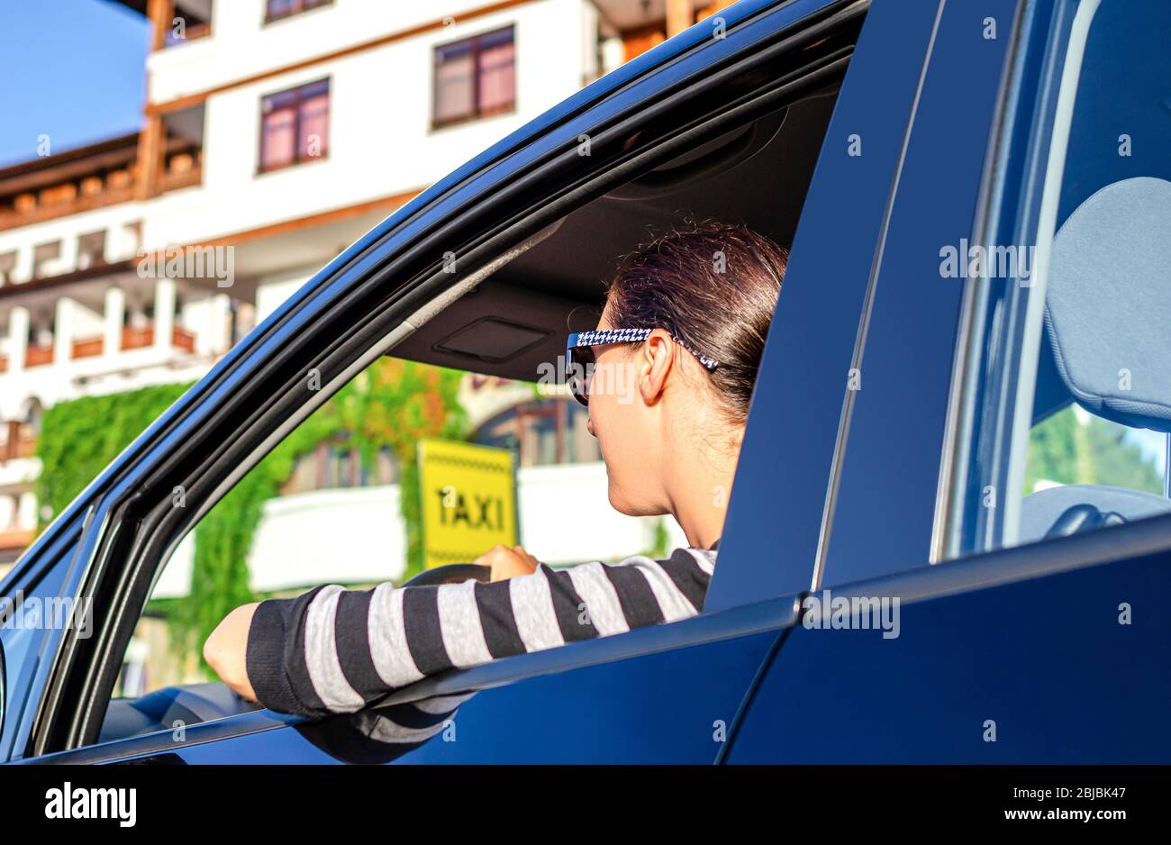 Beautiful female driver sitting in car Stock Photo - Alamy