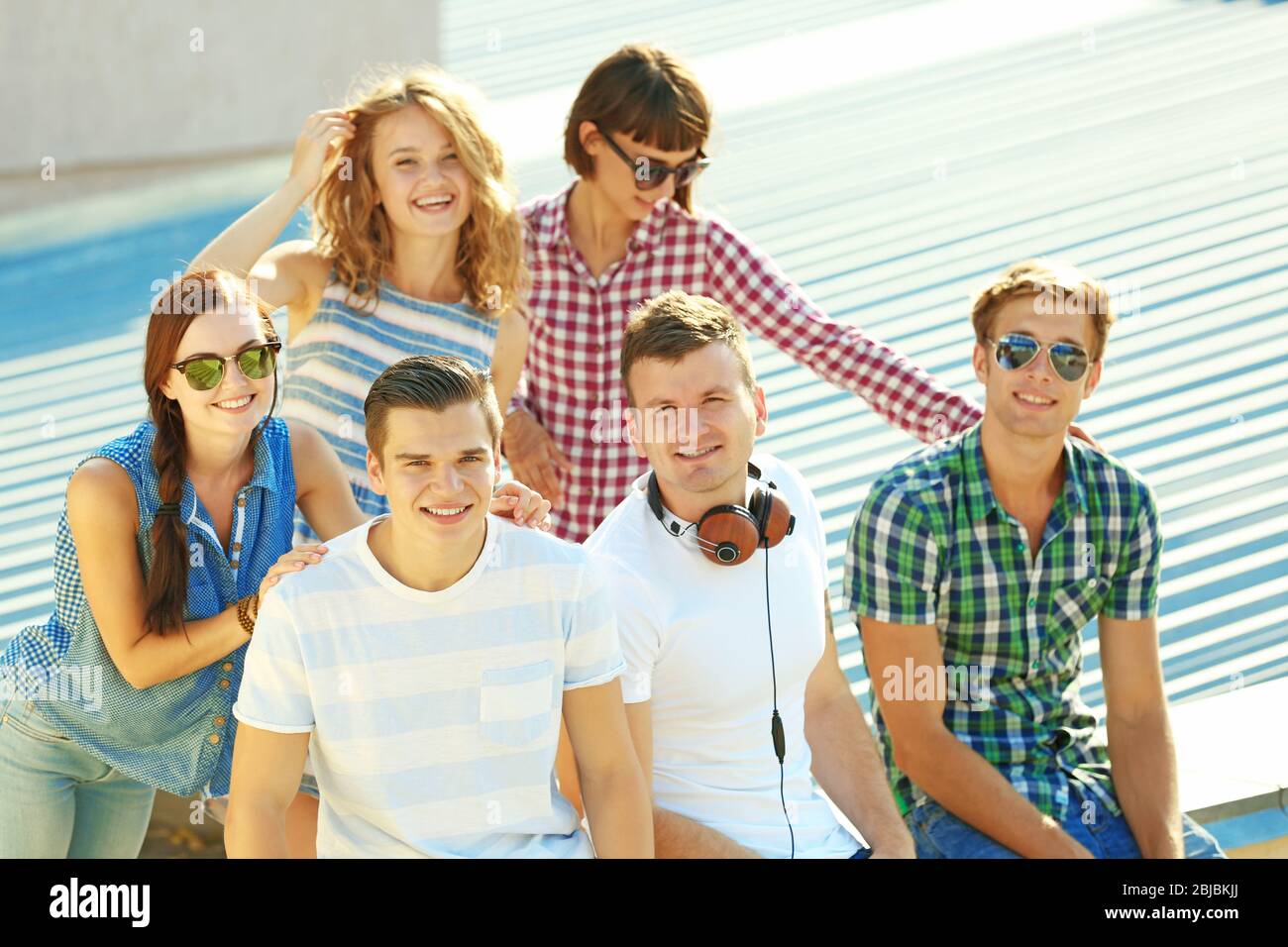 Happy friends hanging out together on street Stock Photo - Alamy