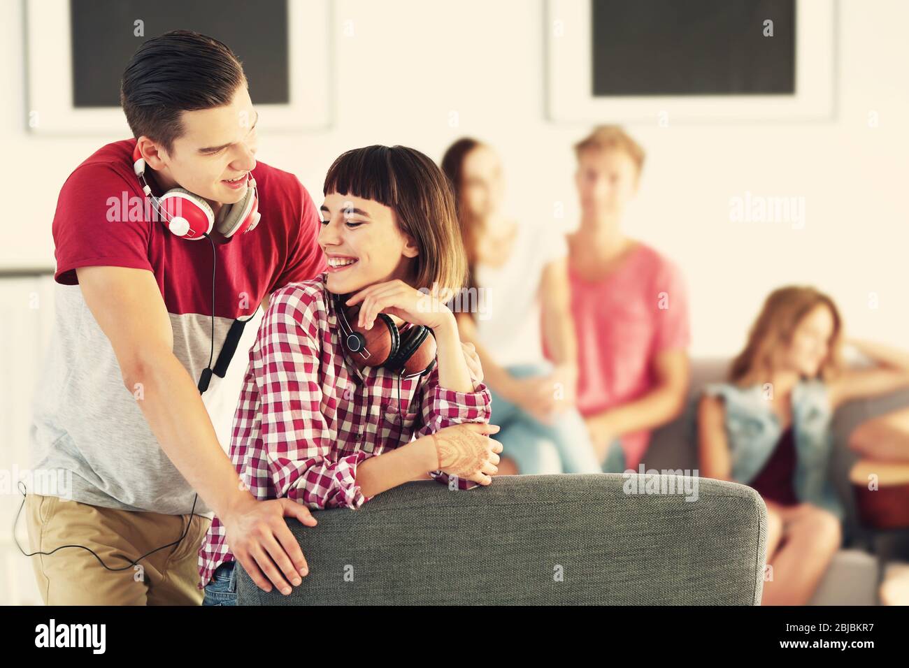 Happy friends listening to music at home Stock Photo - Alamy