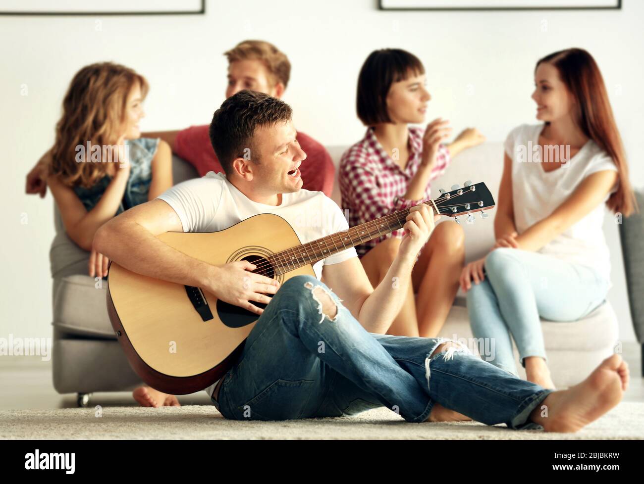 Female students playing acoustic hi-res stock photography and images ...
