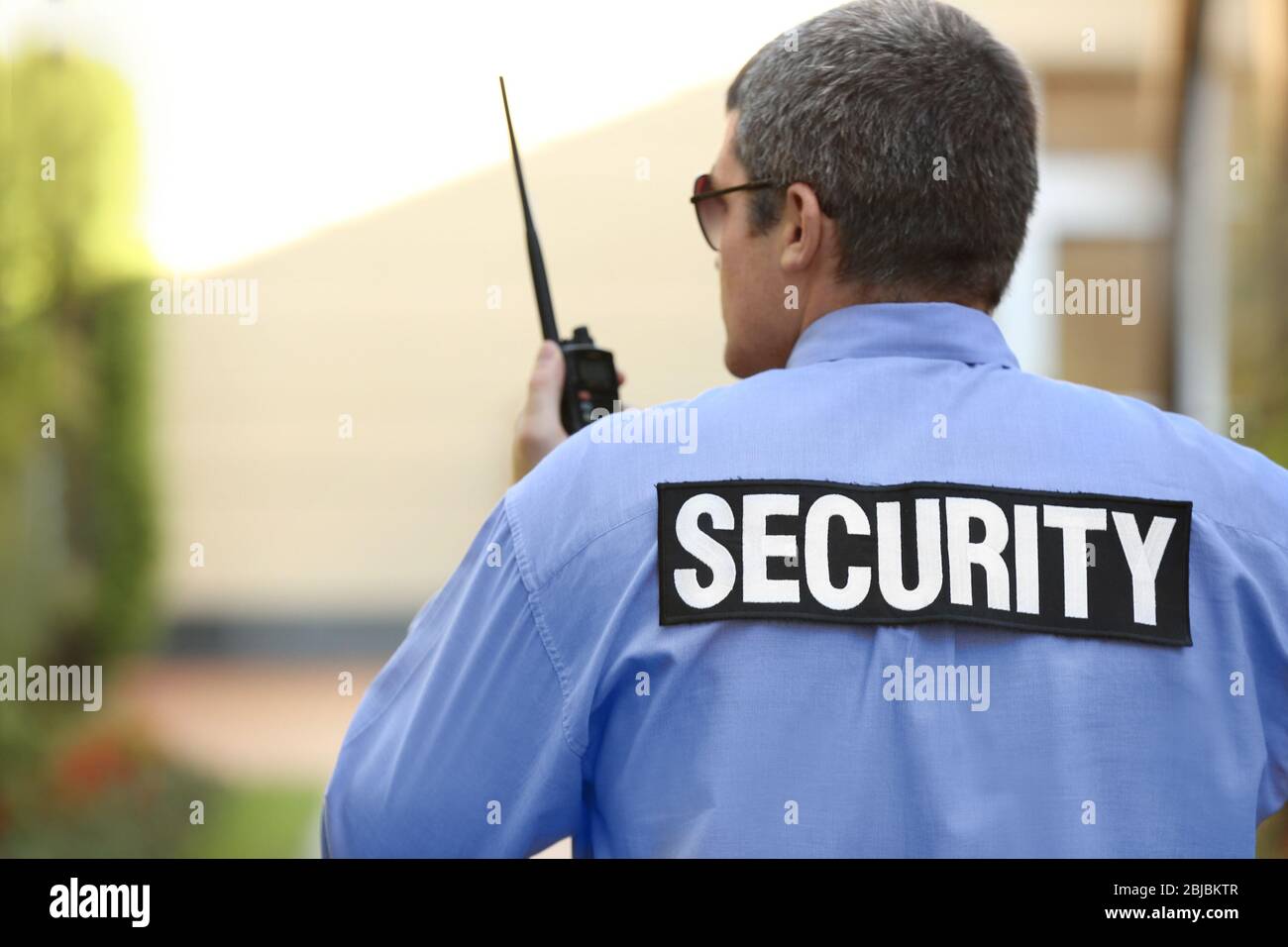 Male security guard protecting house outdoor Stock Photo - Alamy