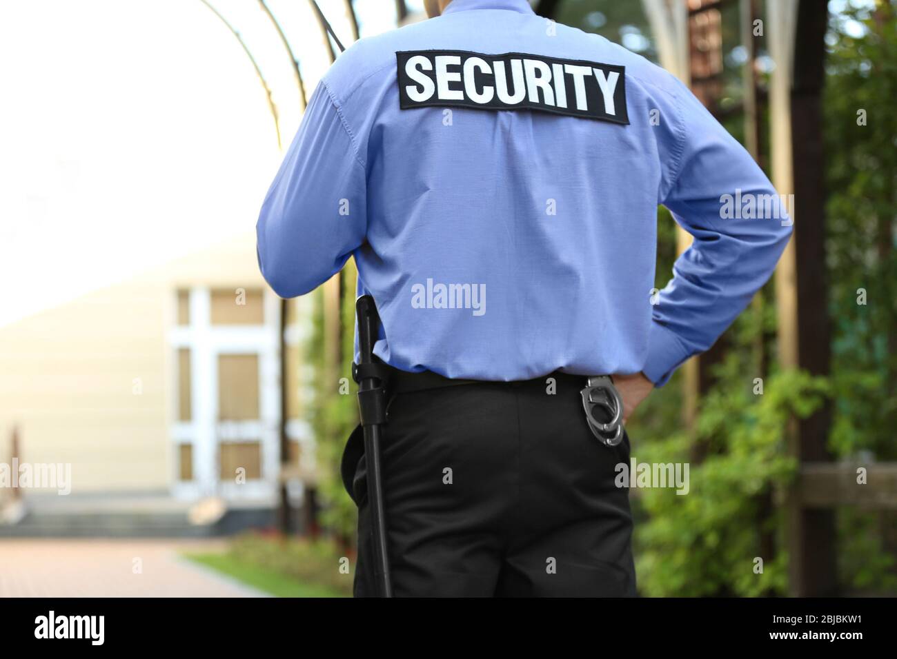 Male security guard protecting house outdoor Stock Photo - Alamy