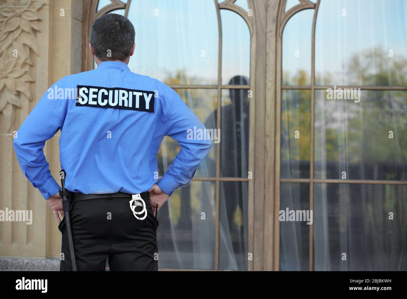 Male security guard protecting house outdoor Stock Photo - Alamy