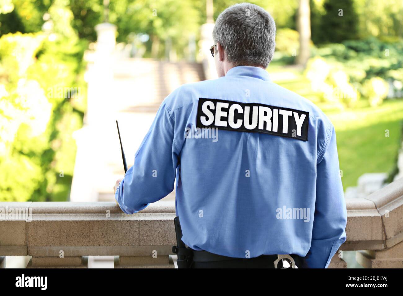 Male security guard protecting house outdoor Stock Photo - Alamy