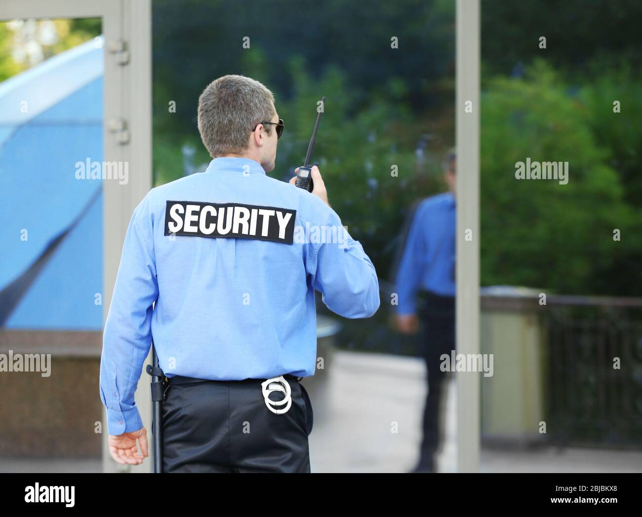 Male security guard protecting house outdoor Stock Photo - Alamy