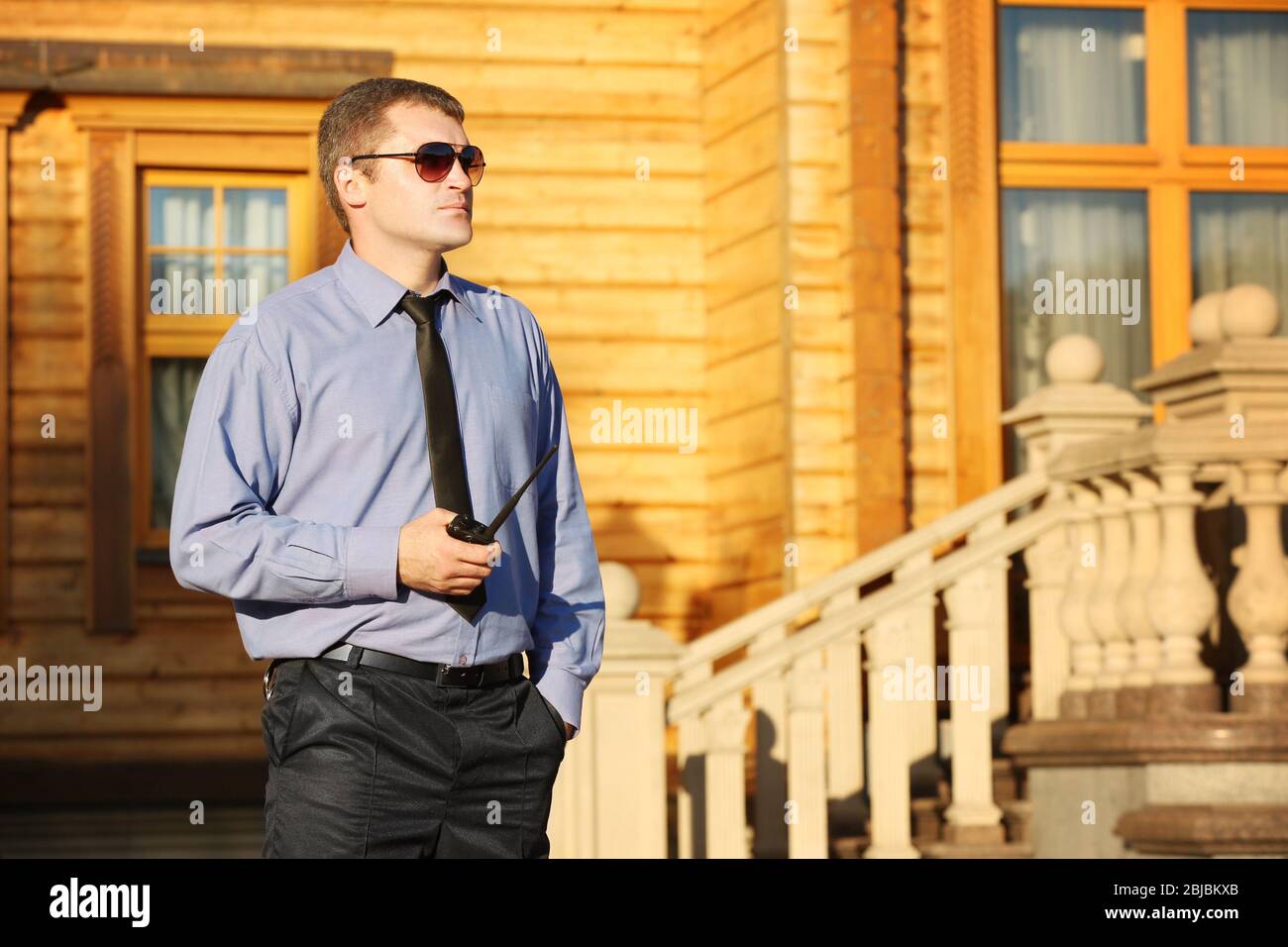 Male security guard protecting house outdoor Stock Photo - Alamy