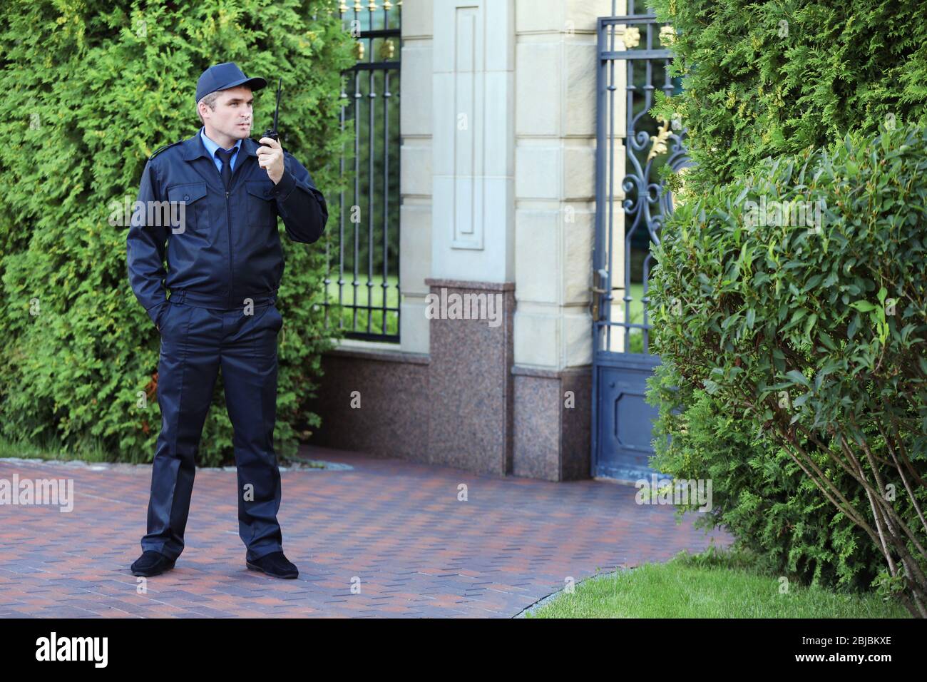 Male security guard in park Stock Photo - Alamy