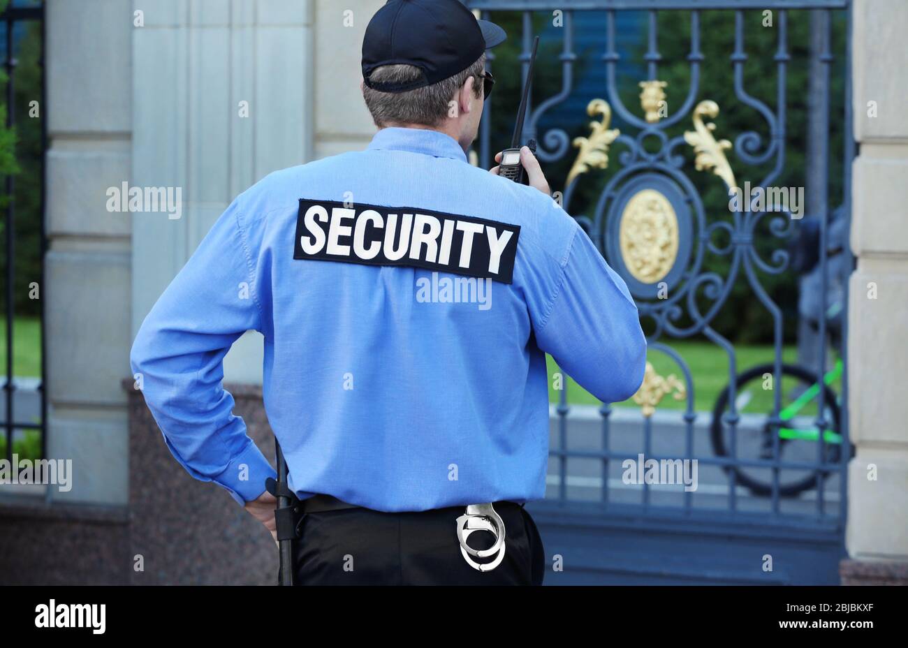 Male security guard protecting house outdoor Stock Photo - Alamy