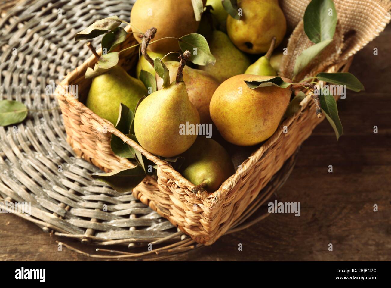 Fresh pears in wicker box closeup Stock Photo - Alamy