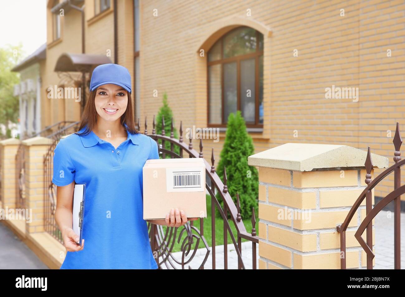 Portrait courier delivering package hi-res stock photography and images ...