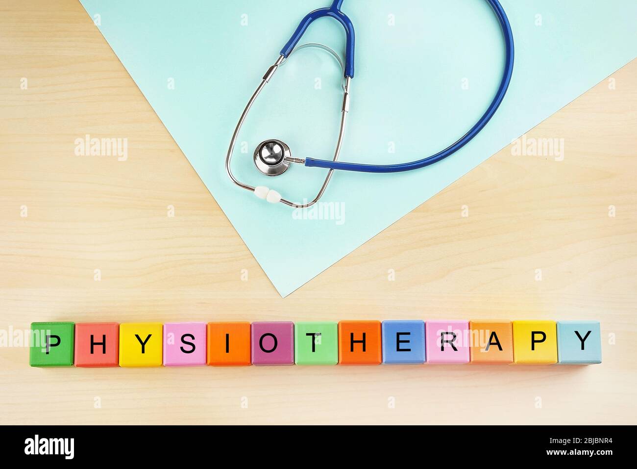 Medical stethoscope and word physiotherapy on wooden background Stock ...