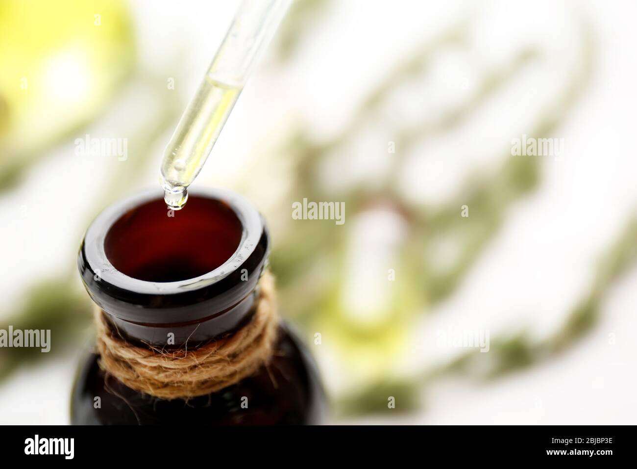 Glass dropper and bottle of coniferous essential oil, close up view ...