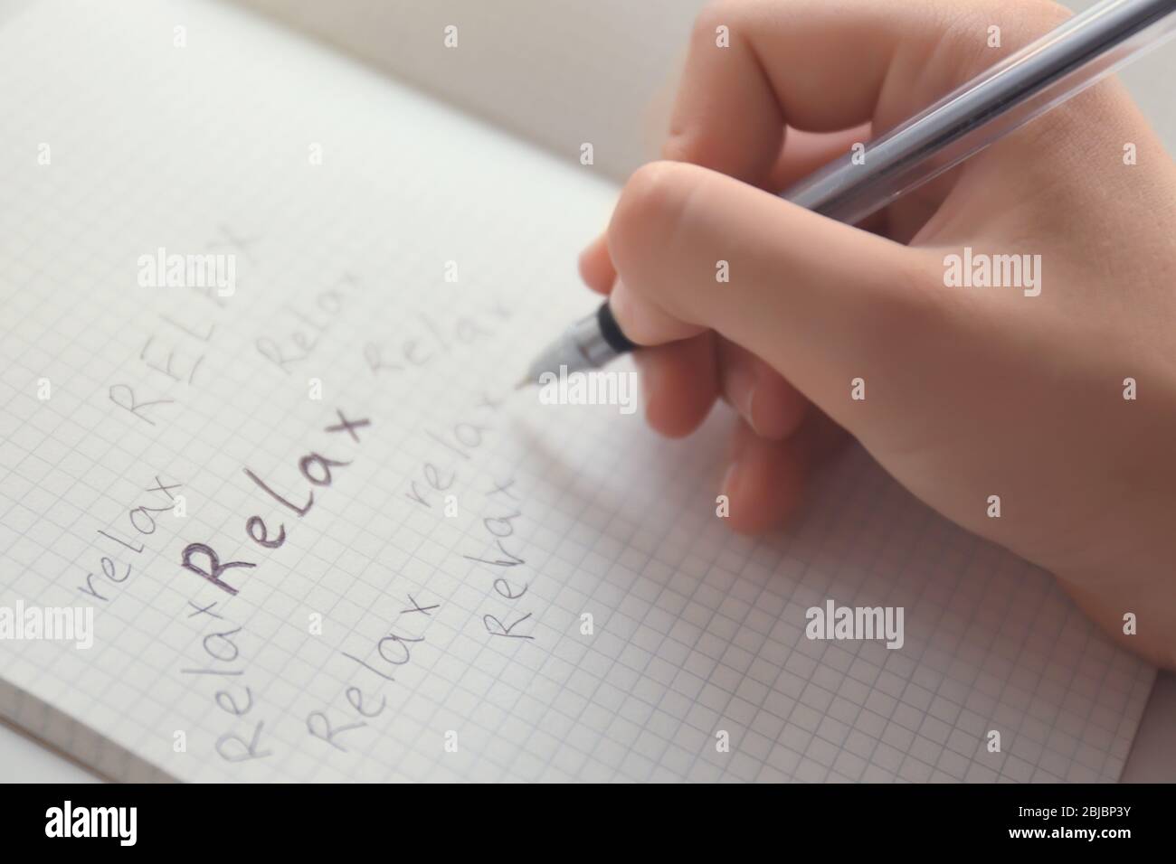 Female hand writing word "relax" in notebook, close up view Stock Photo ...