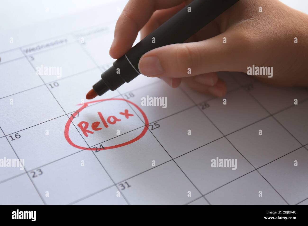 Female hand writing word "relax" in day planner, close up view Stock ...