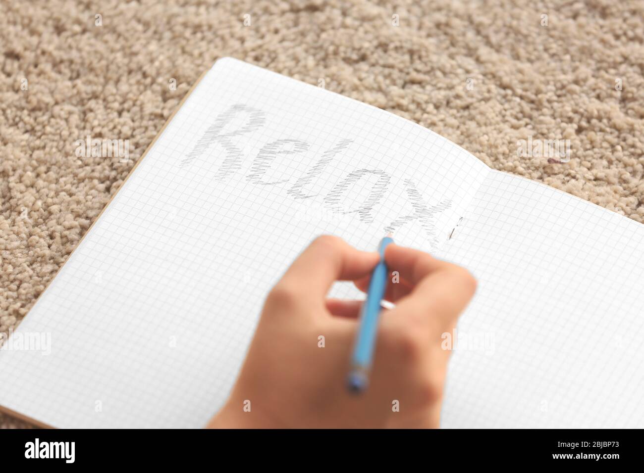 Female hand writing word "relax" in notebook, close up view Stock Photo ...