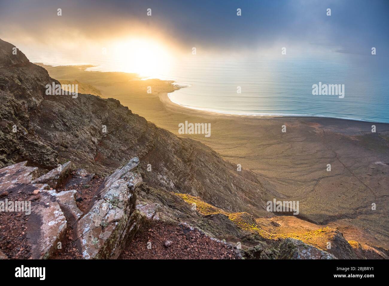 Dramatic sunset over the west coast of Lanzarote, as seen from near ...