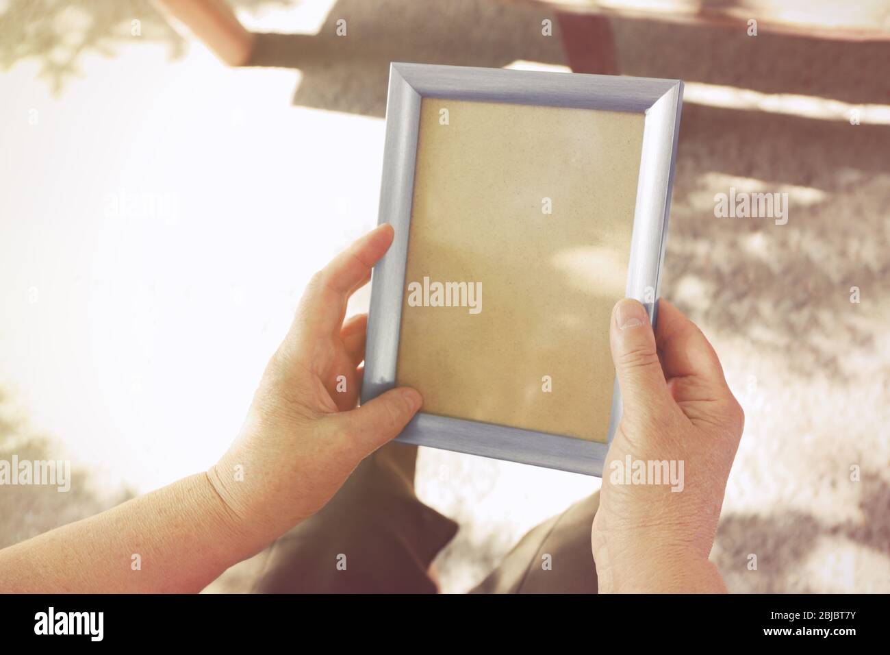 Old woman holding photo frame. Memories concept Stock Photo - Alamy
