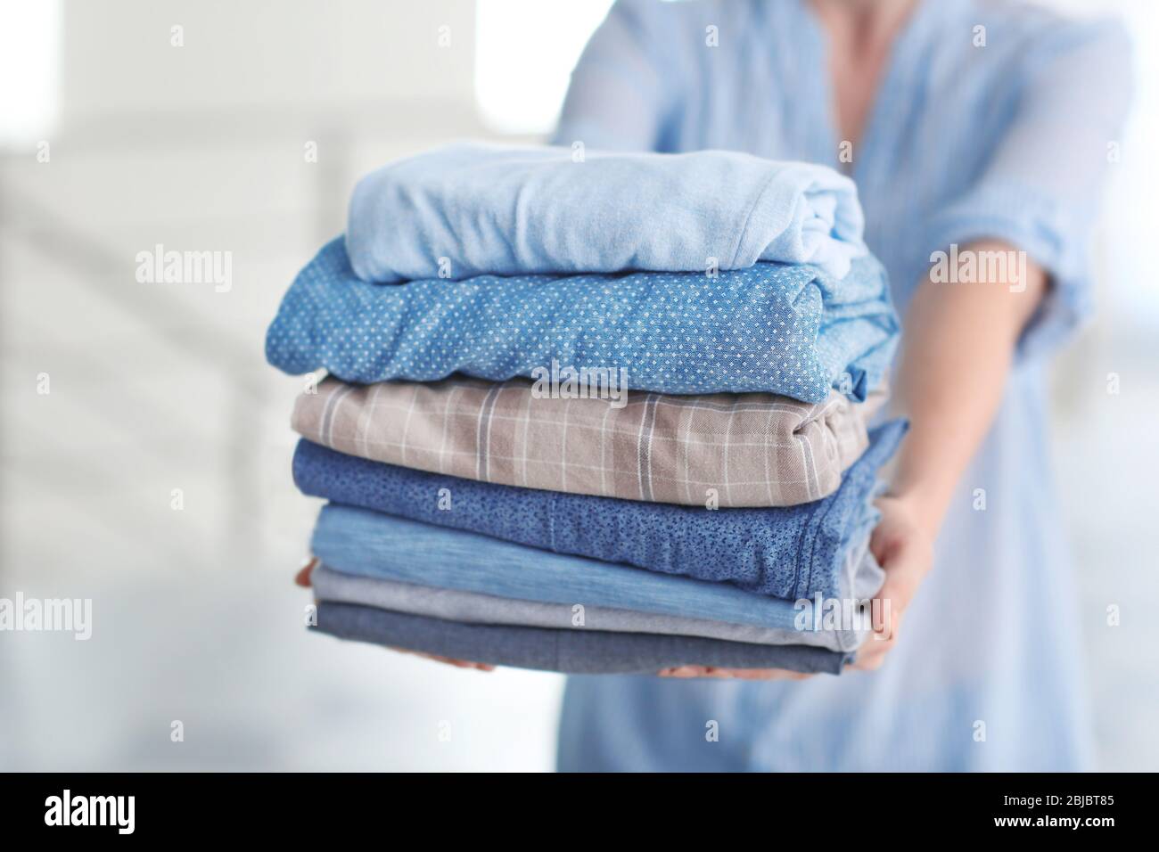 Holding fold clothes hi-res stock photography and images - Alamy
