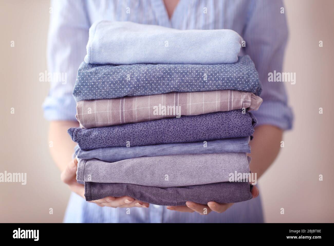 Holding fold clothes hi-res stock photography and images - Alamy