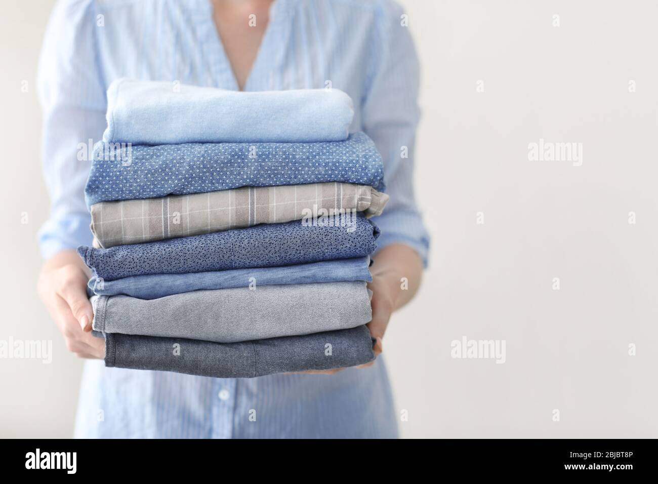 Holding fold clothes hi-res stock photography and images - Alamy