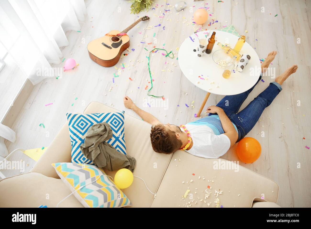 Tired drunk man after party at home Stock Photo - Alamy