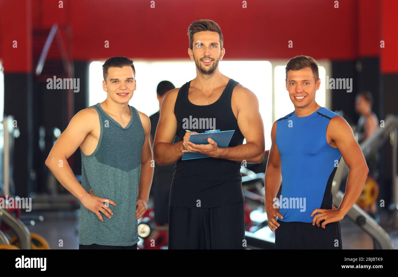 Portrait of men with personal trainer Stock Photo - Alamy
