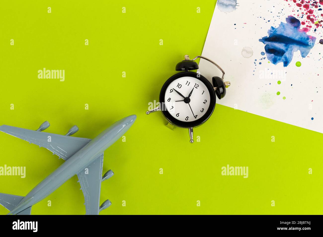 Time to travel concept. plastic plane jet toy passenger with alarm ...