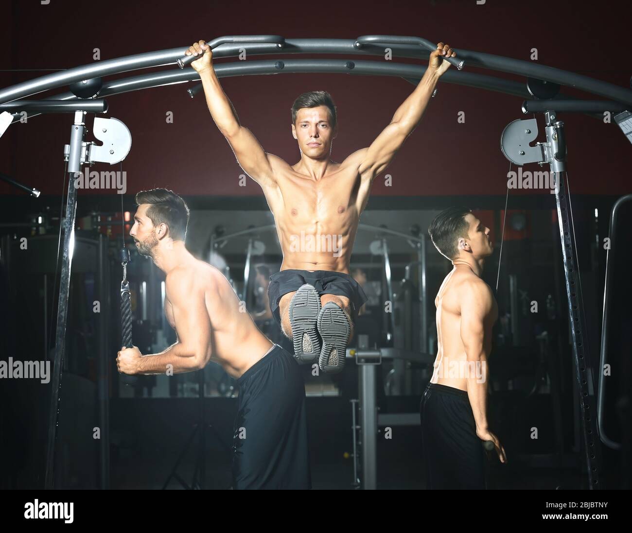 Athletic men training in modern gym Stock Photo - Alamy