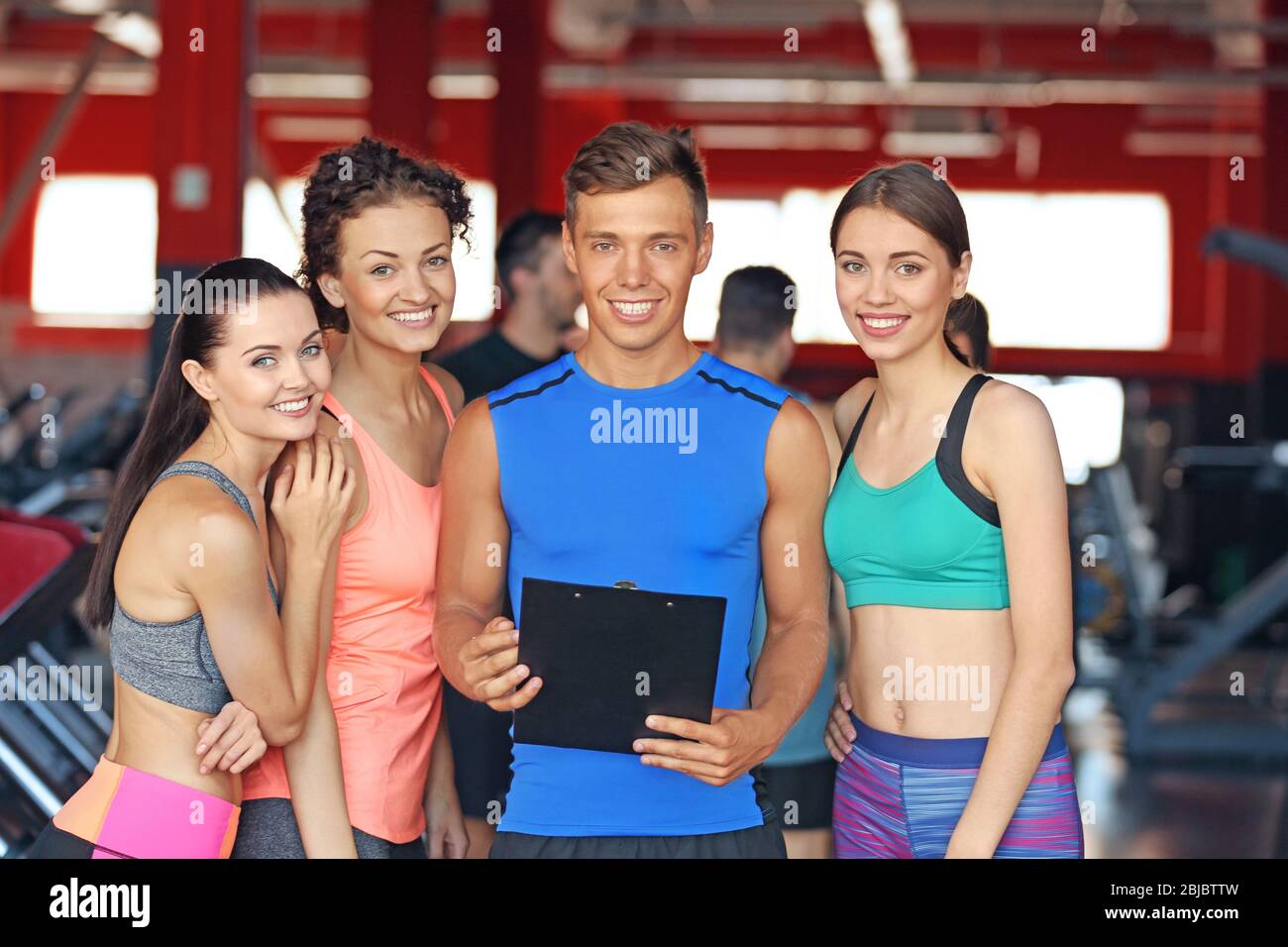 Group of women with personal trainer in gym Stock Photo - Alamy