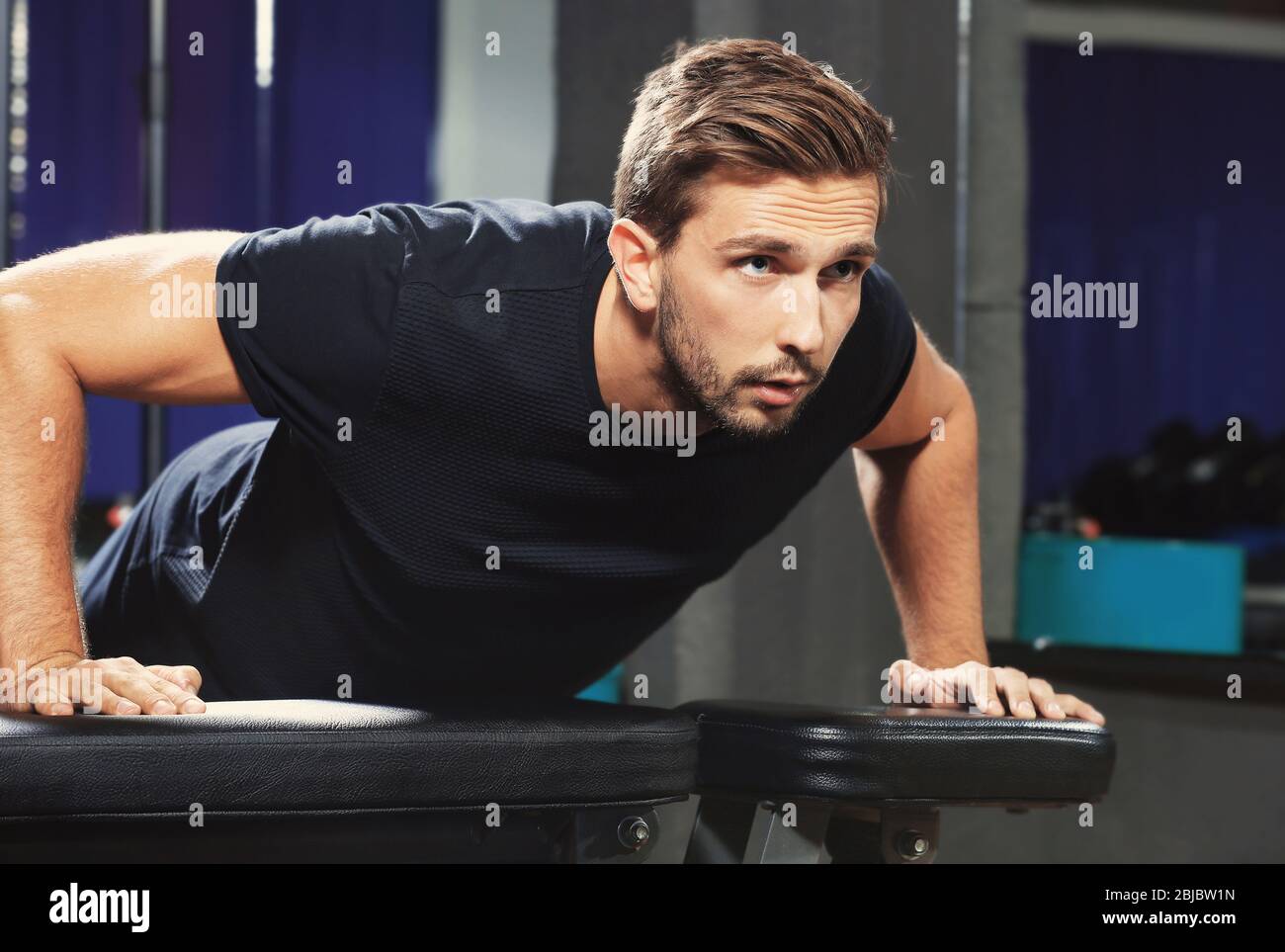 Handsome man doing push ups in gym Stock Photo - Alamy