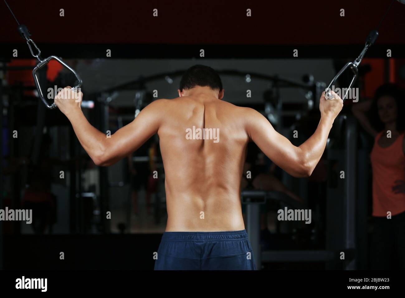 Athletic man training back muscles in gym Stock Photo - Alamy