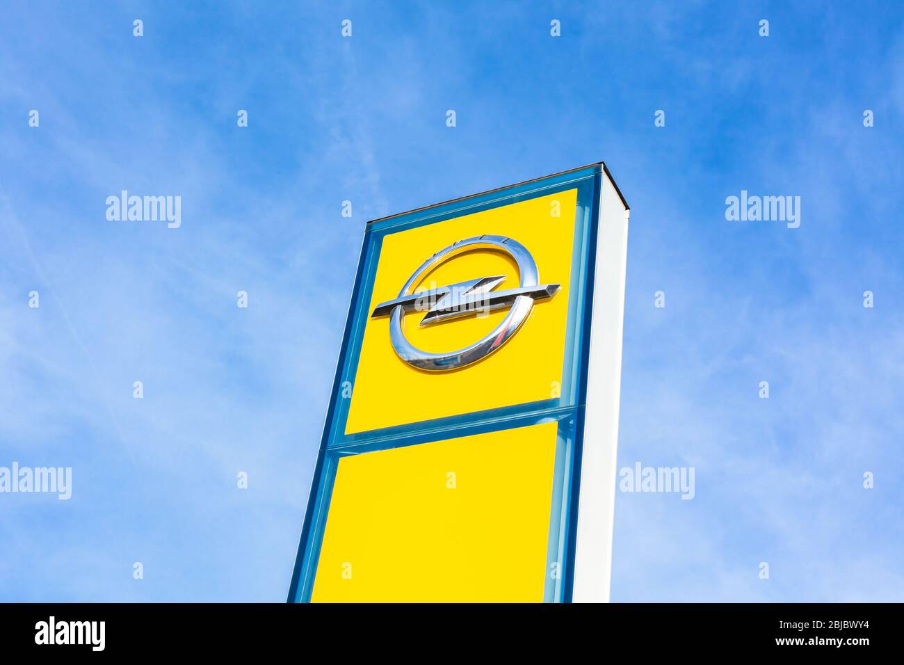 Opel brand logo on bright blue sky background located in Lyon, France ...