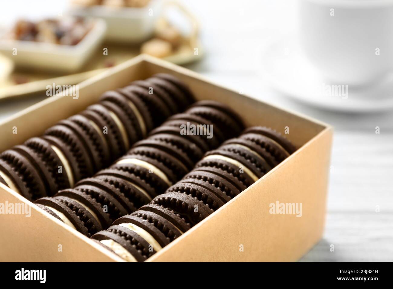 Carton box with tasty chocolate cookies on blurred background Stock ...